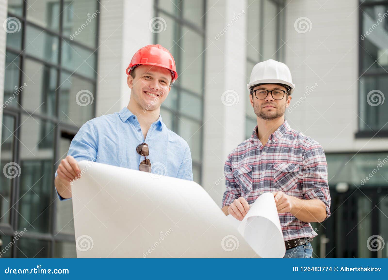 Two Young Talented Engineers are Holding Scheme of Construction Stock ...