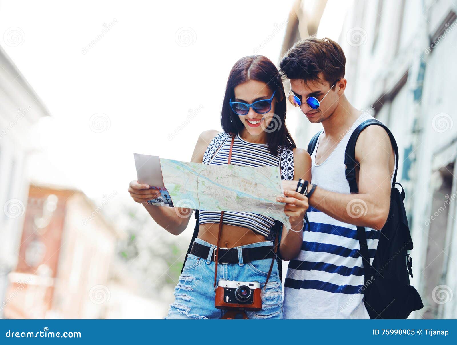 Two Young Tourists Relaxing and Examining a Guide Map Stock Image ...