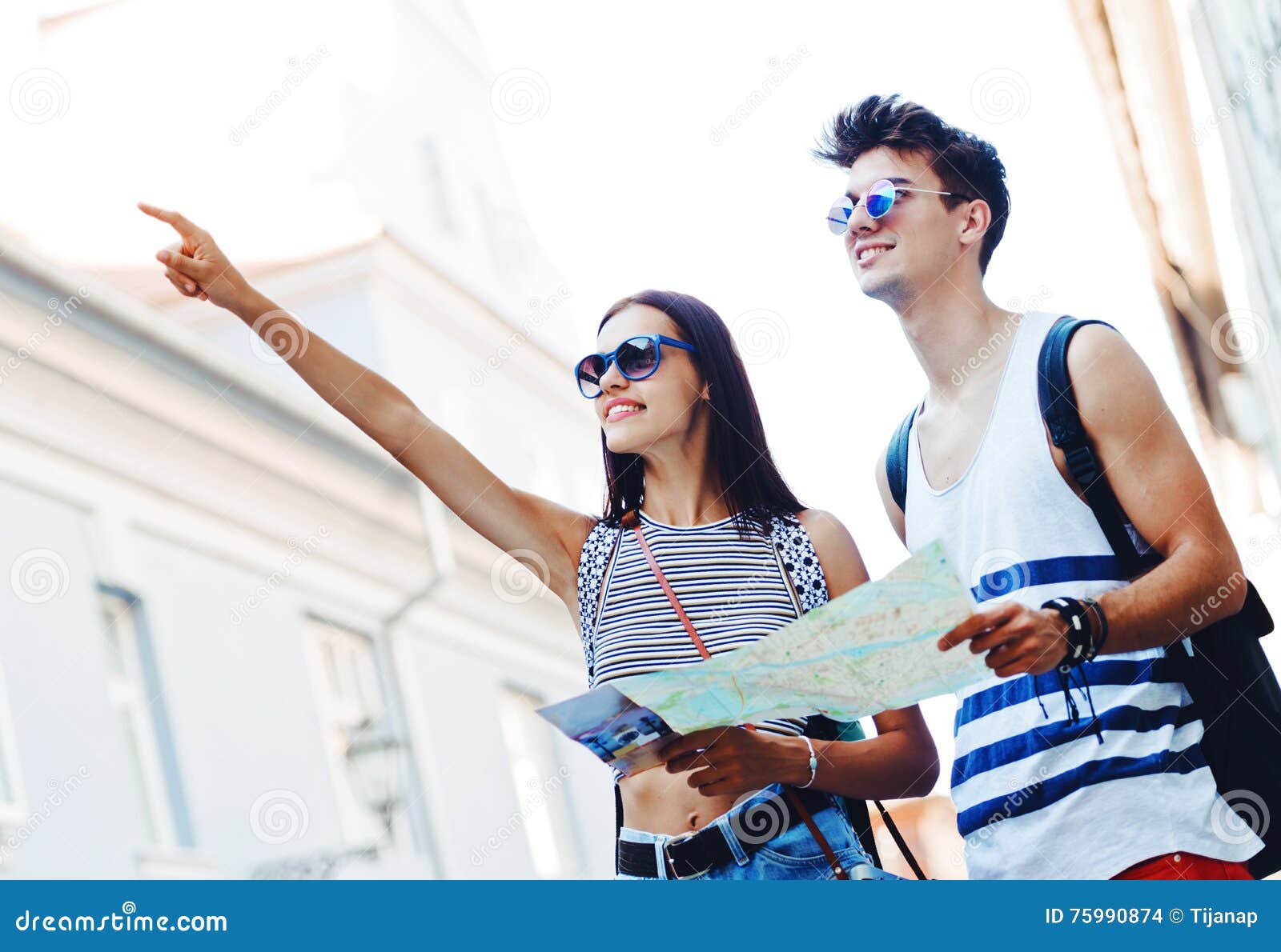 Two Young Tourists Sightseeing a Town, Pointing with Finger Stock Photo ...