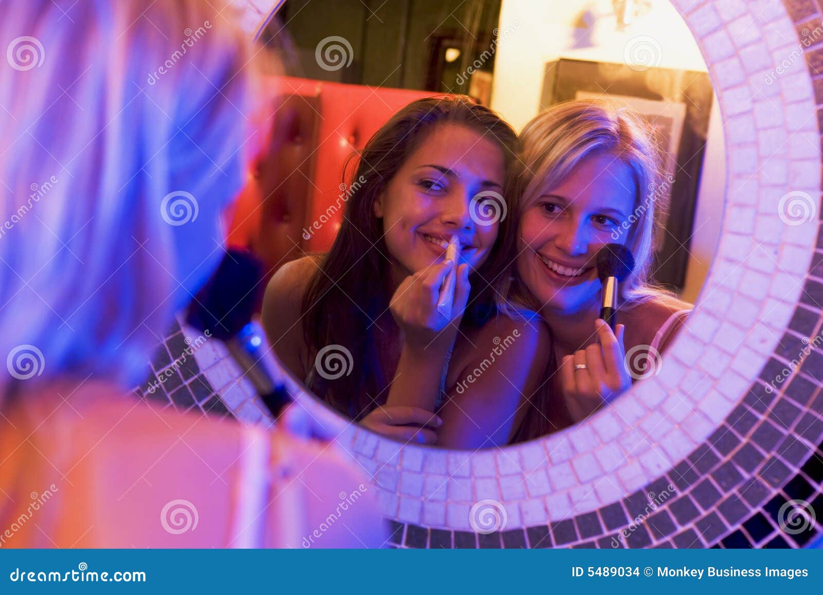 Two Young Women Applying Makeup in a Nightclub Stock Photo - Image of ...