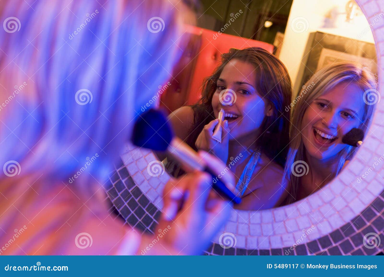 Two Young Women Applying Makeup in a Nightclub Stock Image - Image of ...