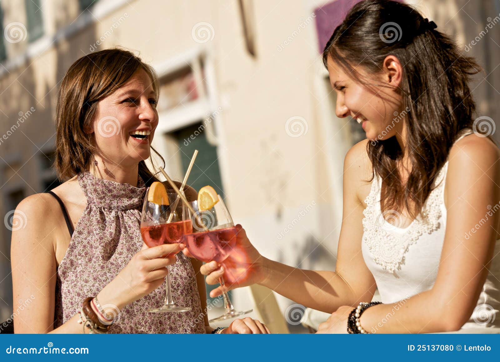 Two Young Women Cheering with Cold Drinks Stock Photo - Image of ...