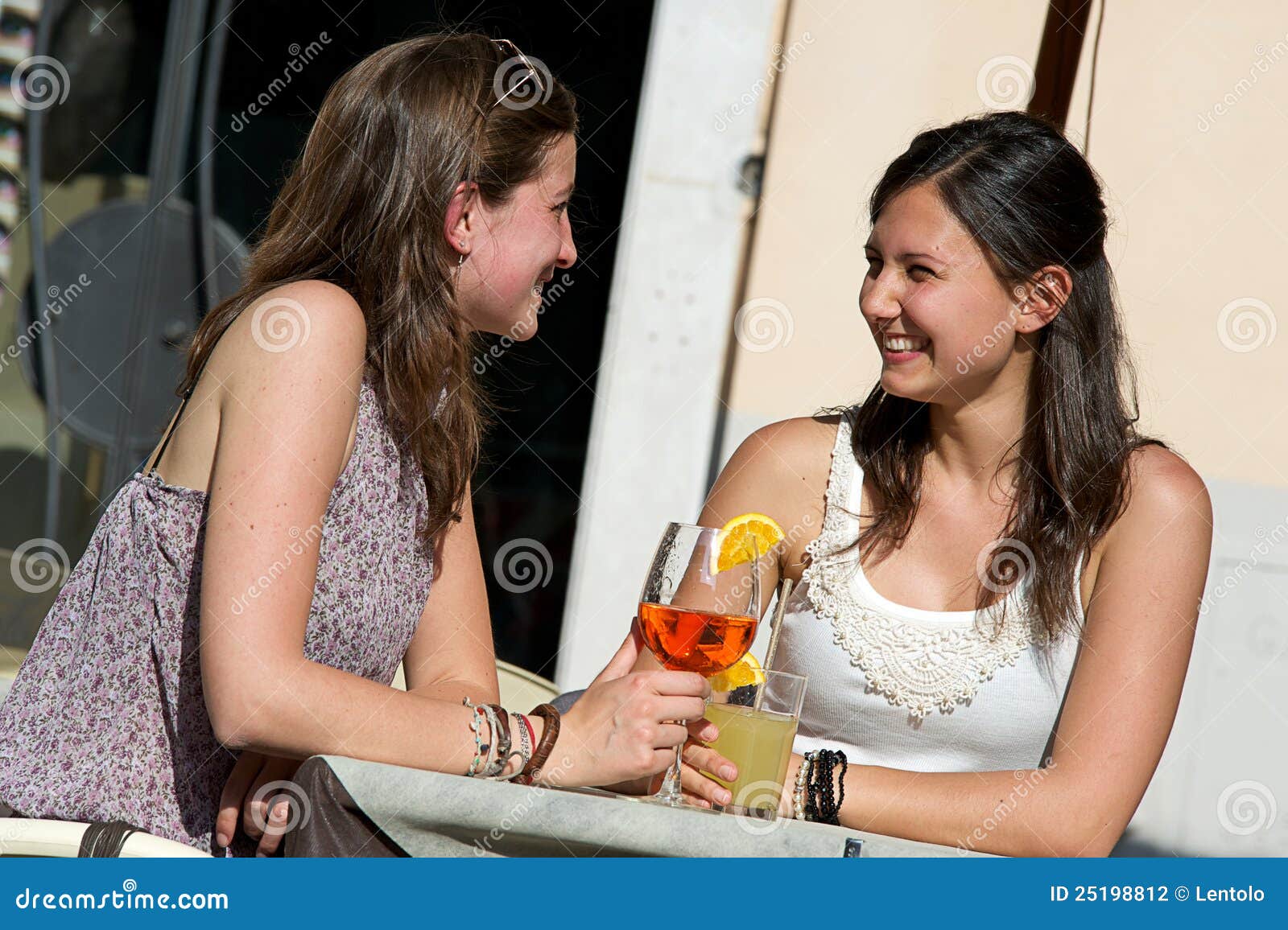 Two Young Women Cheering with Cold Drinks Stock Photo - Image of face ...