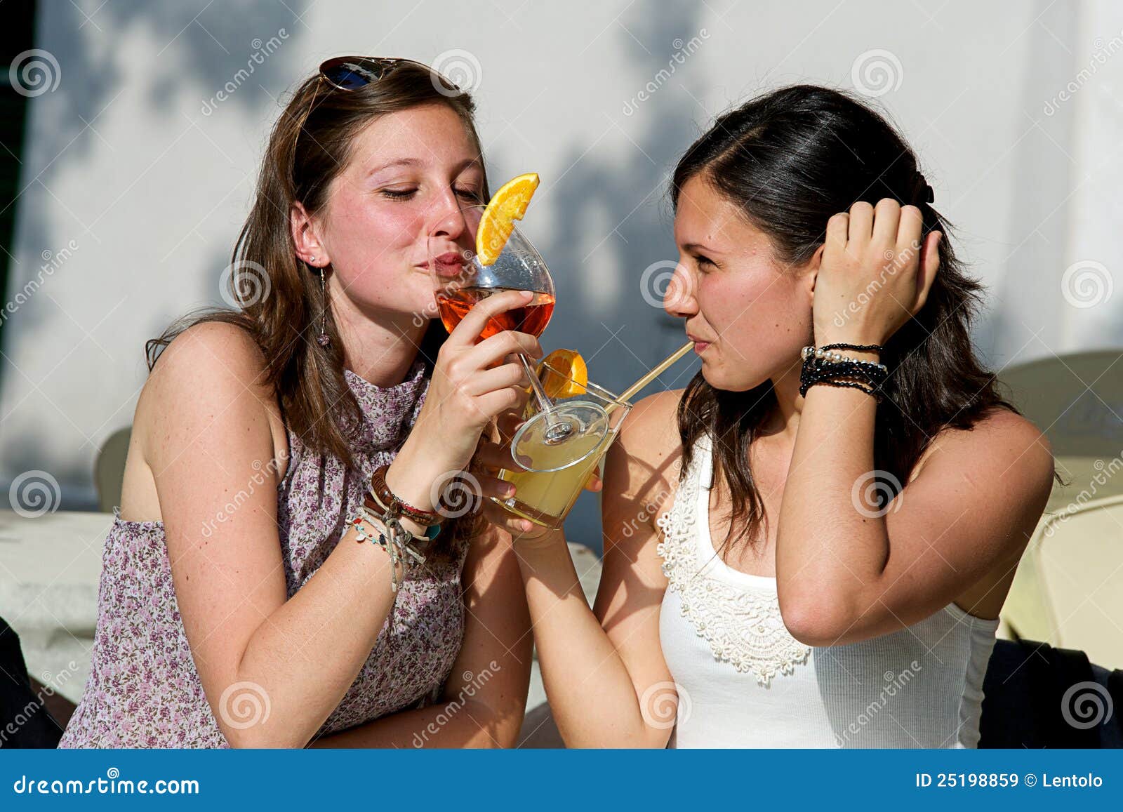 Two Young Women Cheering with Cold Drinks Stock Image - Image of luxury ...