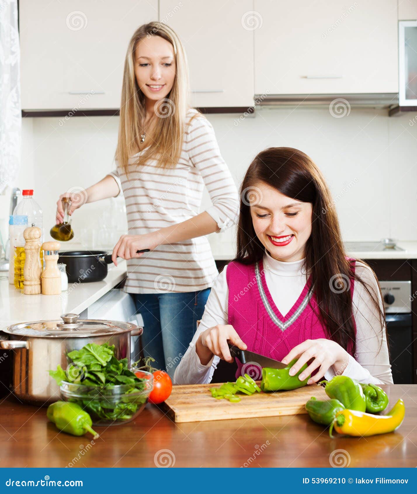 Two Young Women Cooking Something Stock Photo - Image of together ...