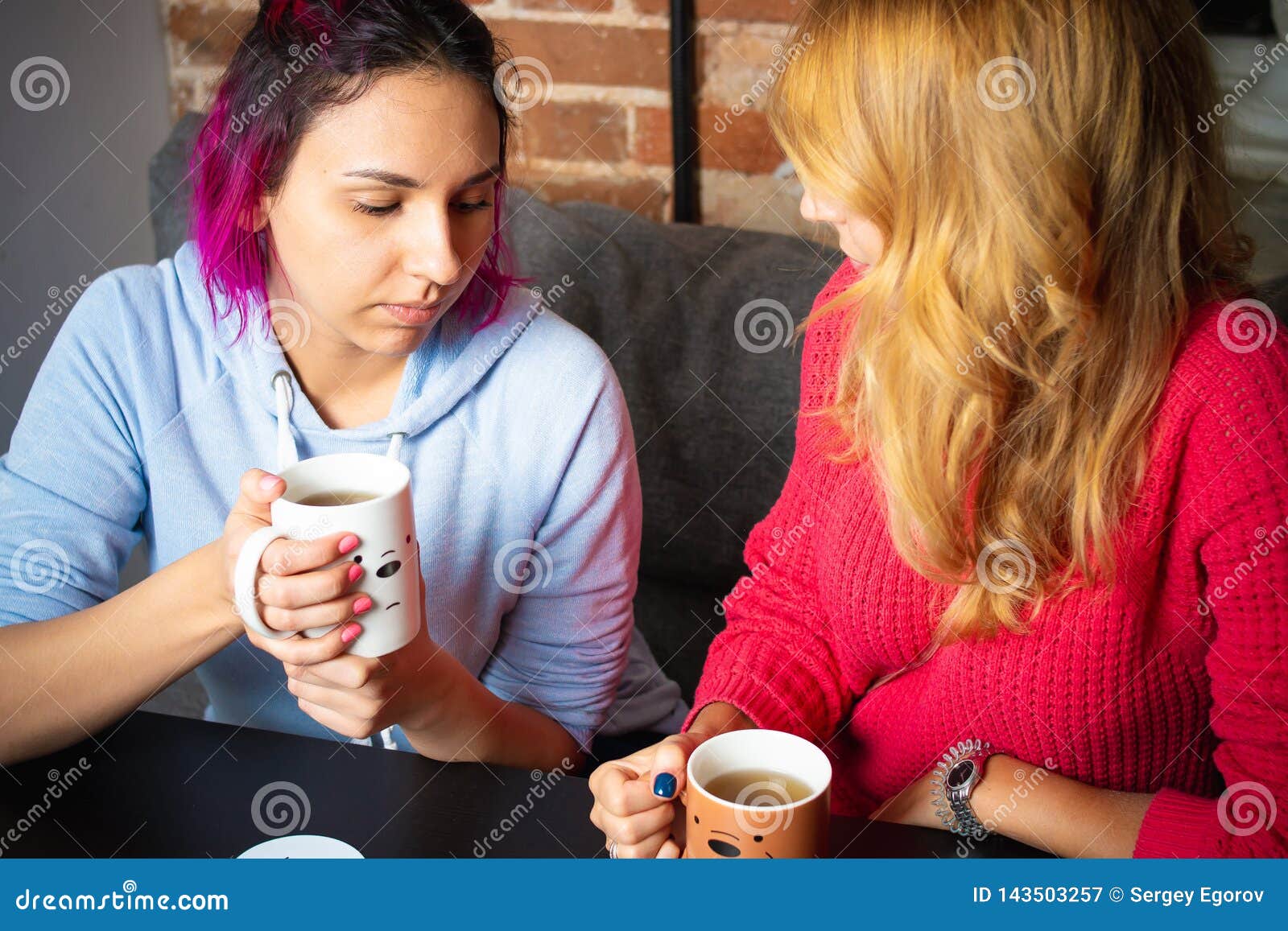 Two Young Women with the Cups of Tea and Coffee Talking Stock Image ...