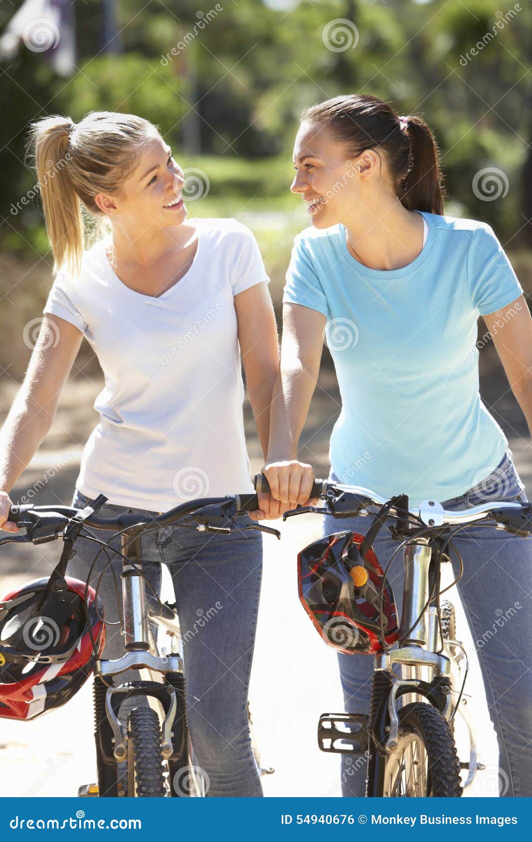 Two Young Women on Cycle Ride Together Stock Photo - Image of woods ...