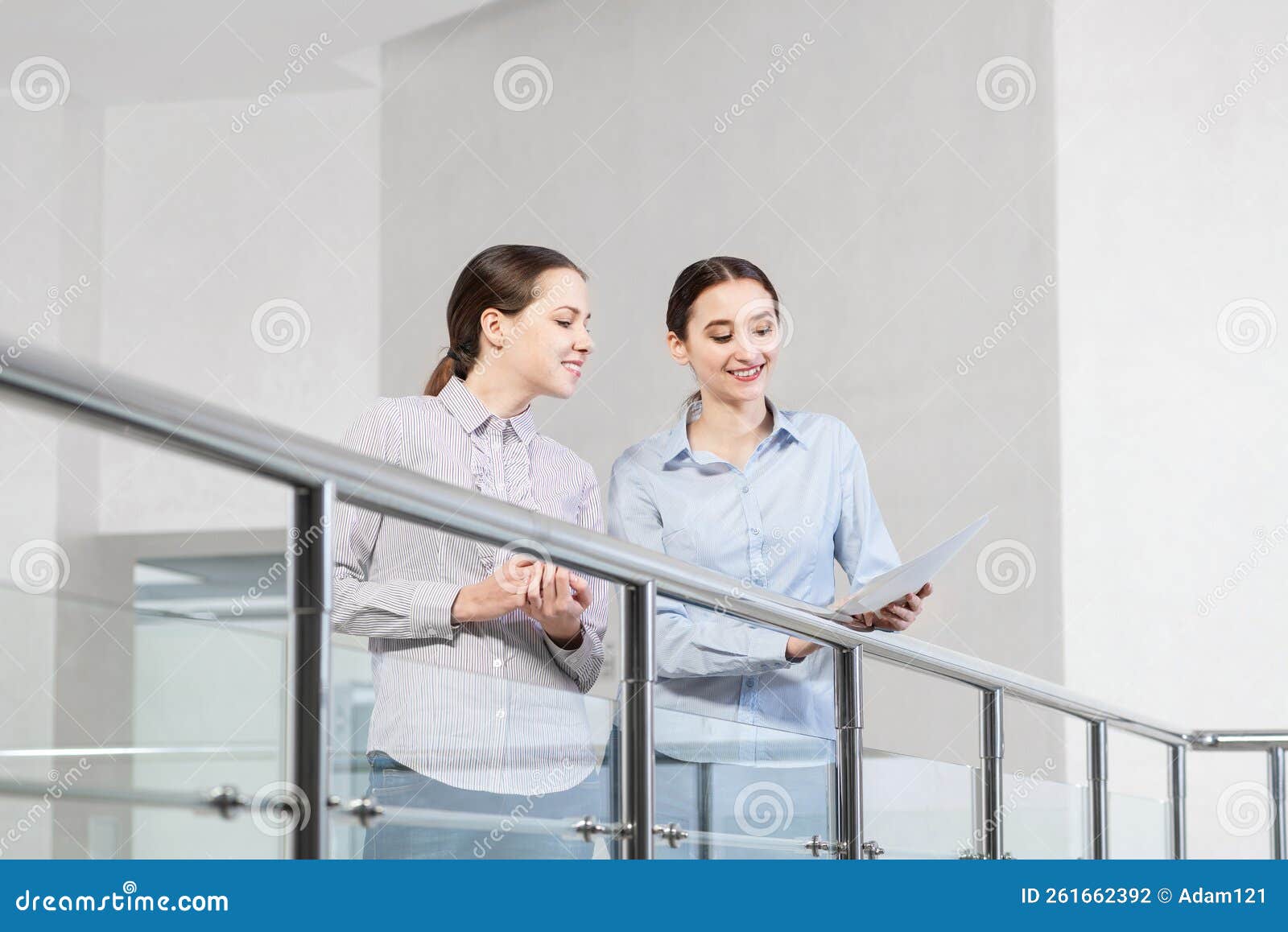 Two Young Women Discuss Documents Stock Photo - Image of documents ...