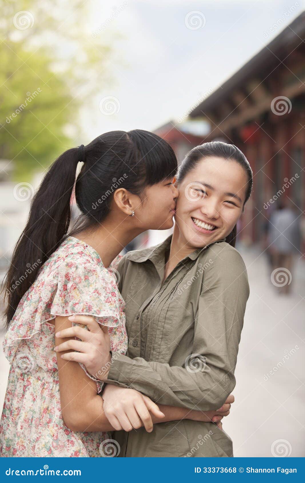 Two young women embracing stock photo. Image of 2024 - 33373668