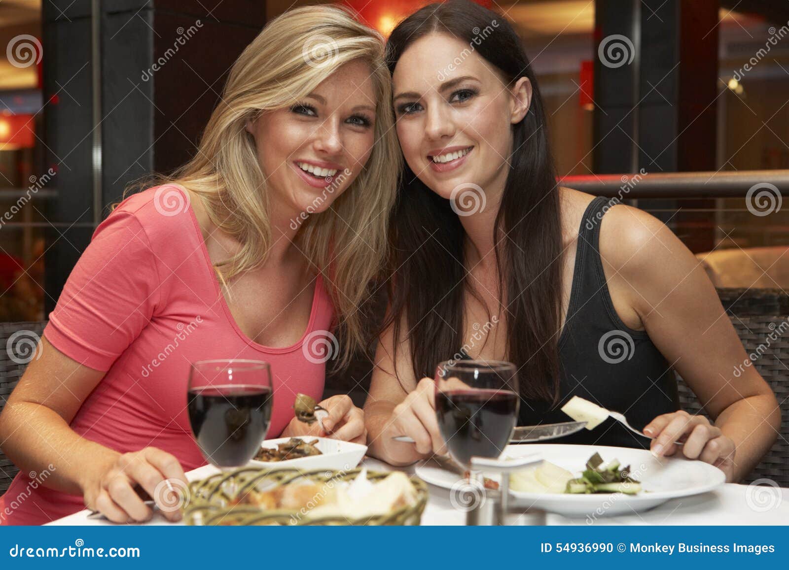 Two Young Women Enjoying Meal in Restaurant Stock Photo - Image of ...