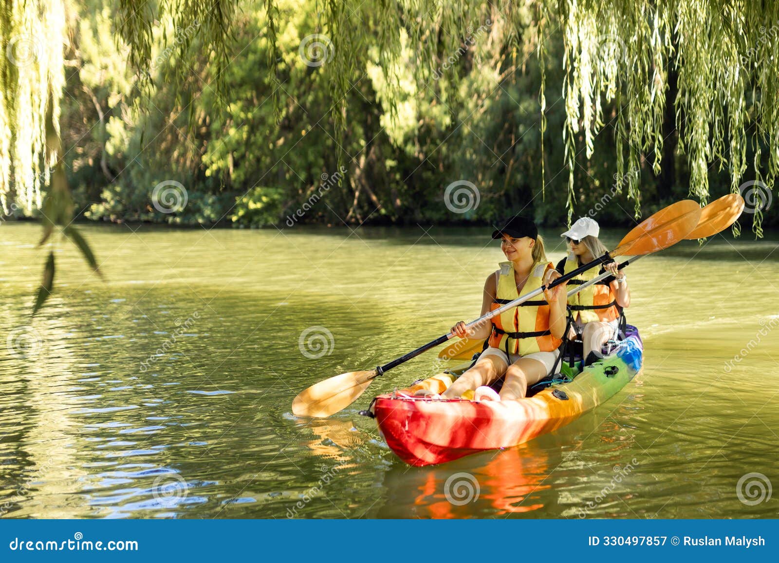 Two Young Women Floating and Smiling in a Kayak on the River. Stock ...