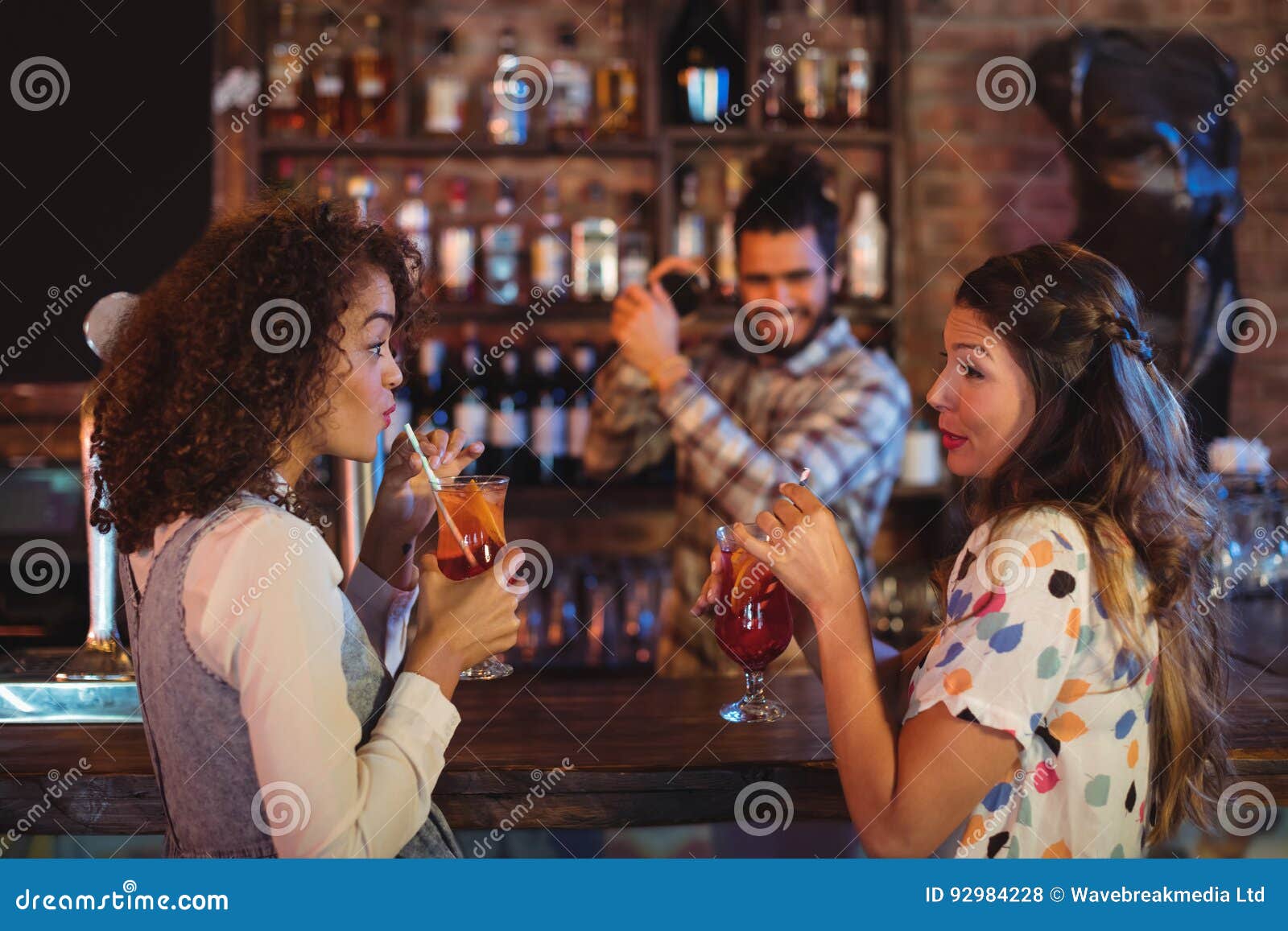 Two Young Women Having Cocktail Drinks at Counter Stock Photo - Image ...