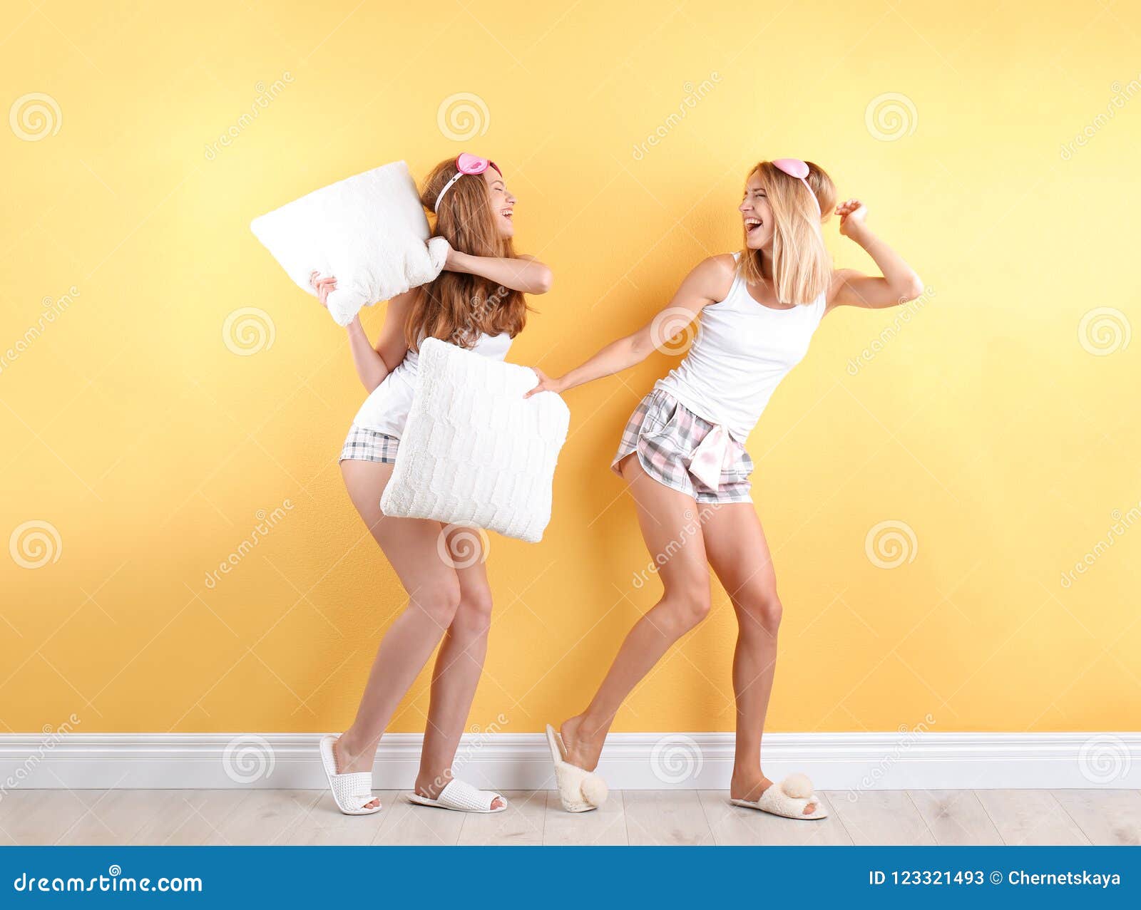 Two Young Women Having Pillow Fight Stock Image Image Of Background
