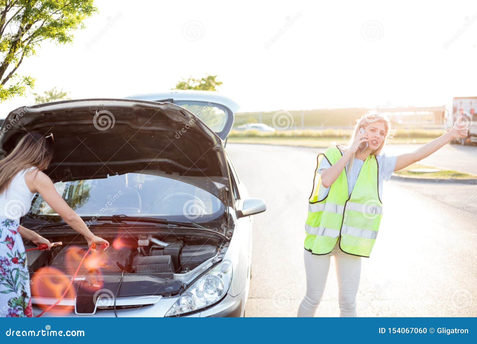 Two Young Women Having Problems with Their Car, Being Stranded on the ...