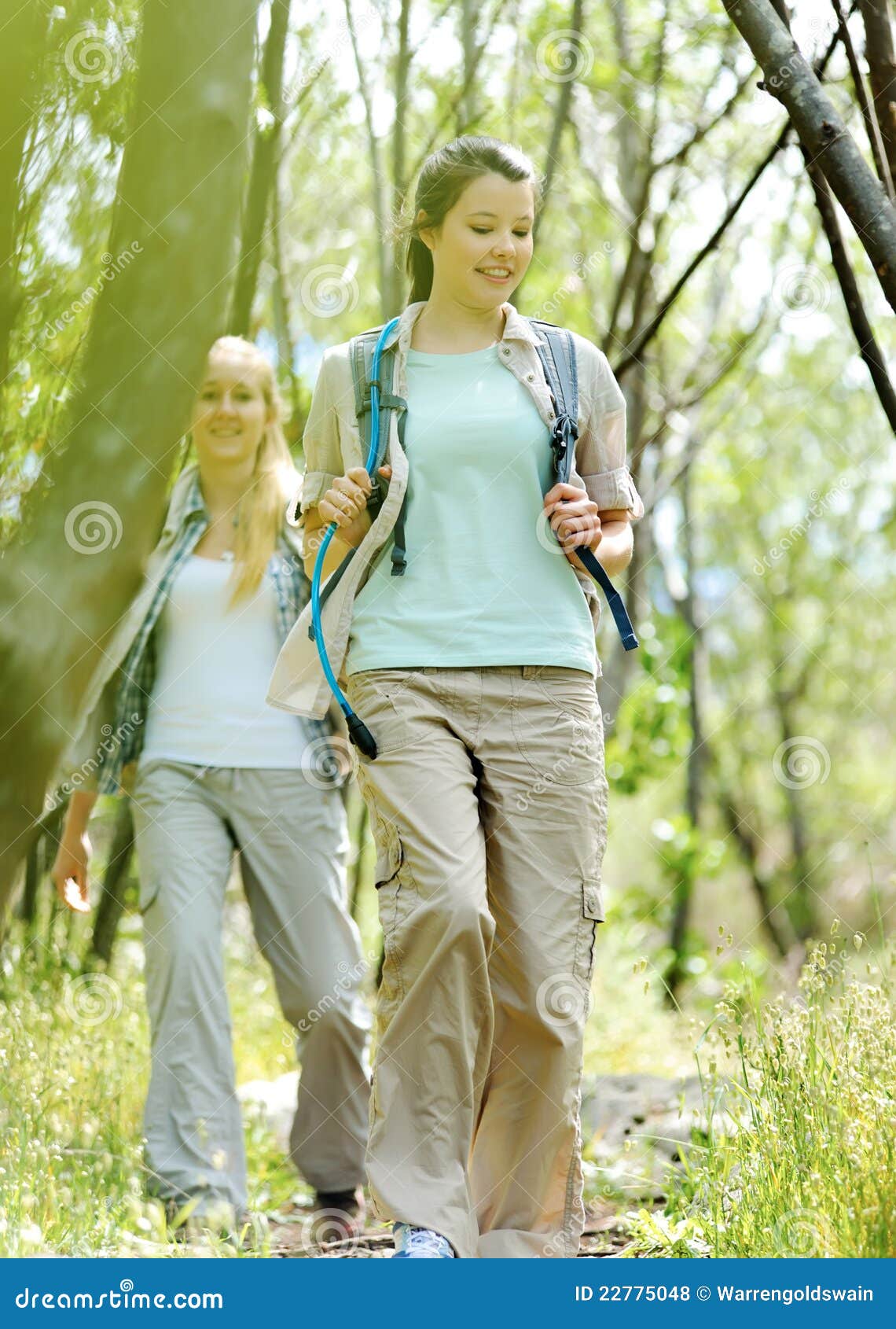Two Young Women Hiking between the Trees Stock Photo - Image of leisure ...