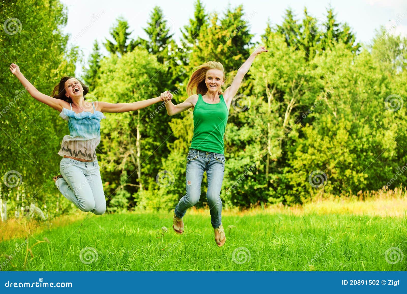 Two young women jumping stock photo. Image of friends - 20891502