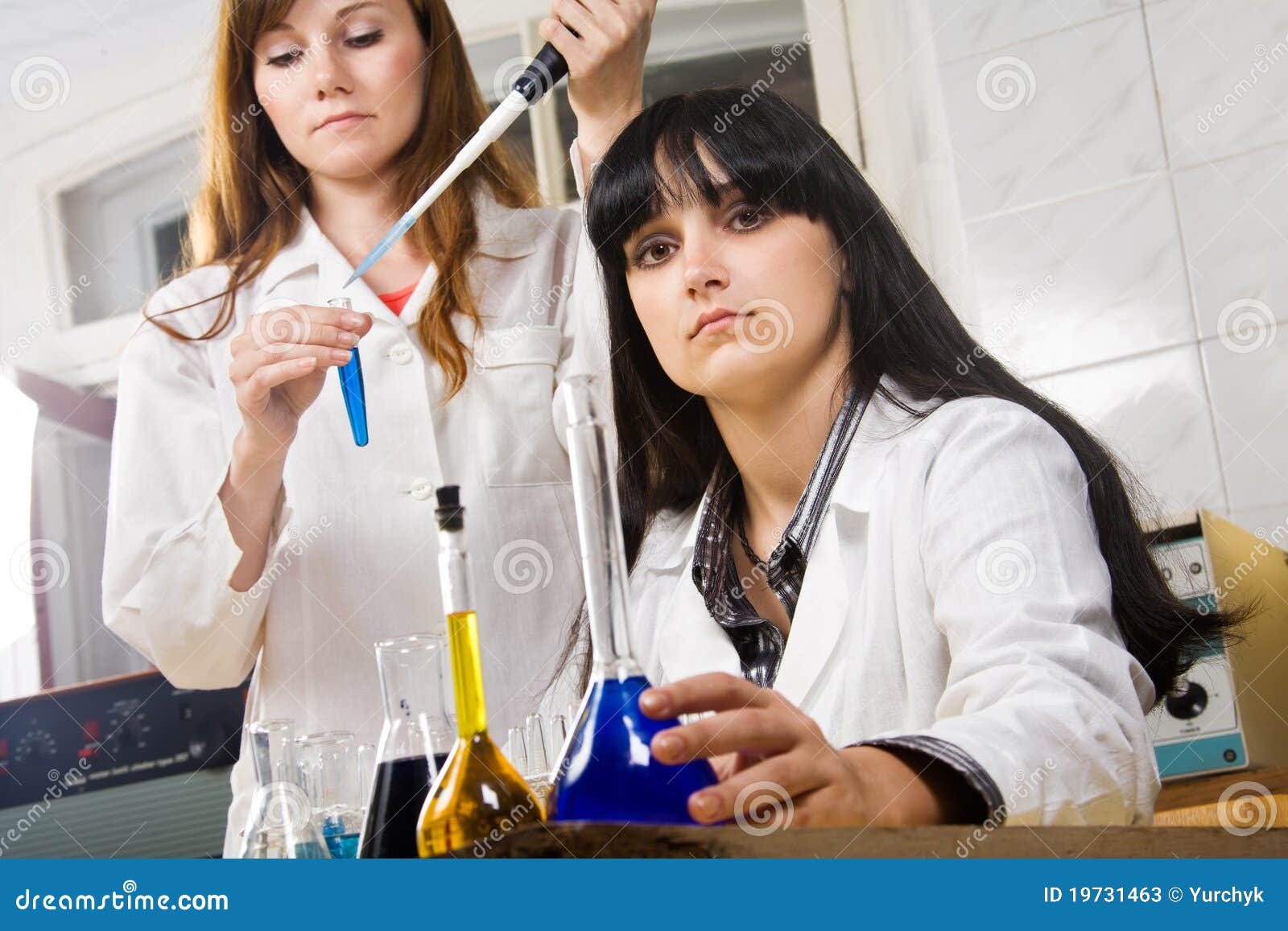 Two young women in a lab stock image. Image of instrument - 19731463
