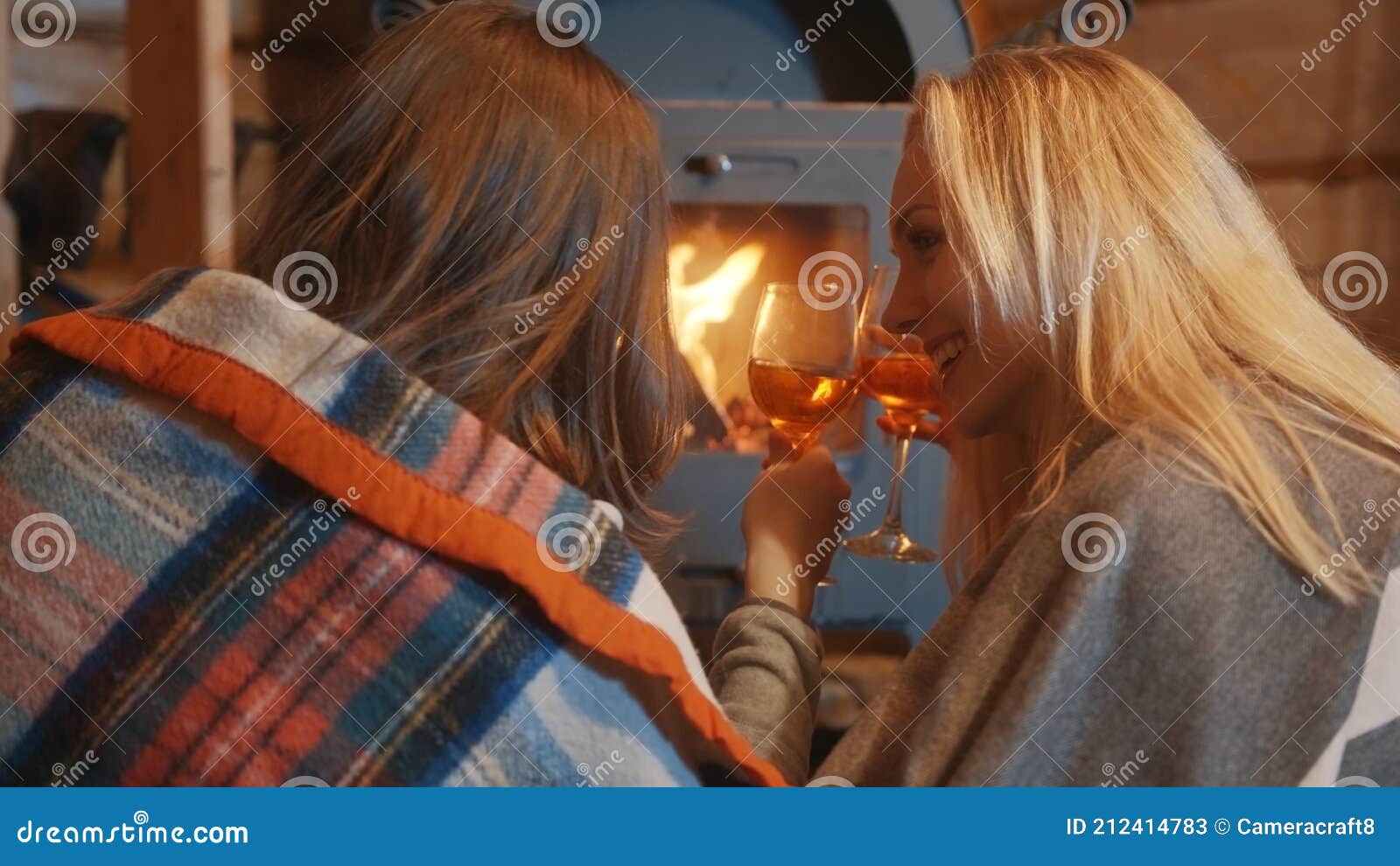 Two Young Women Lesbian Couple Relaxing Near The Fireplace And
