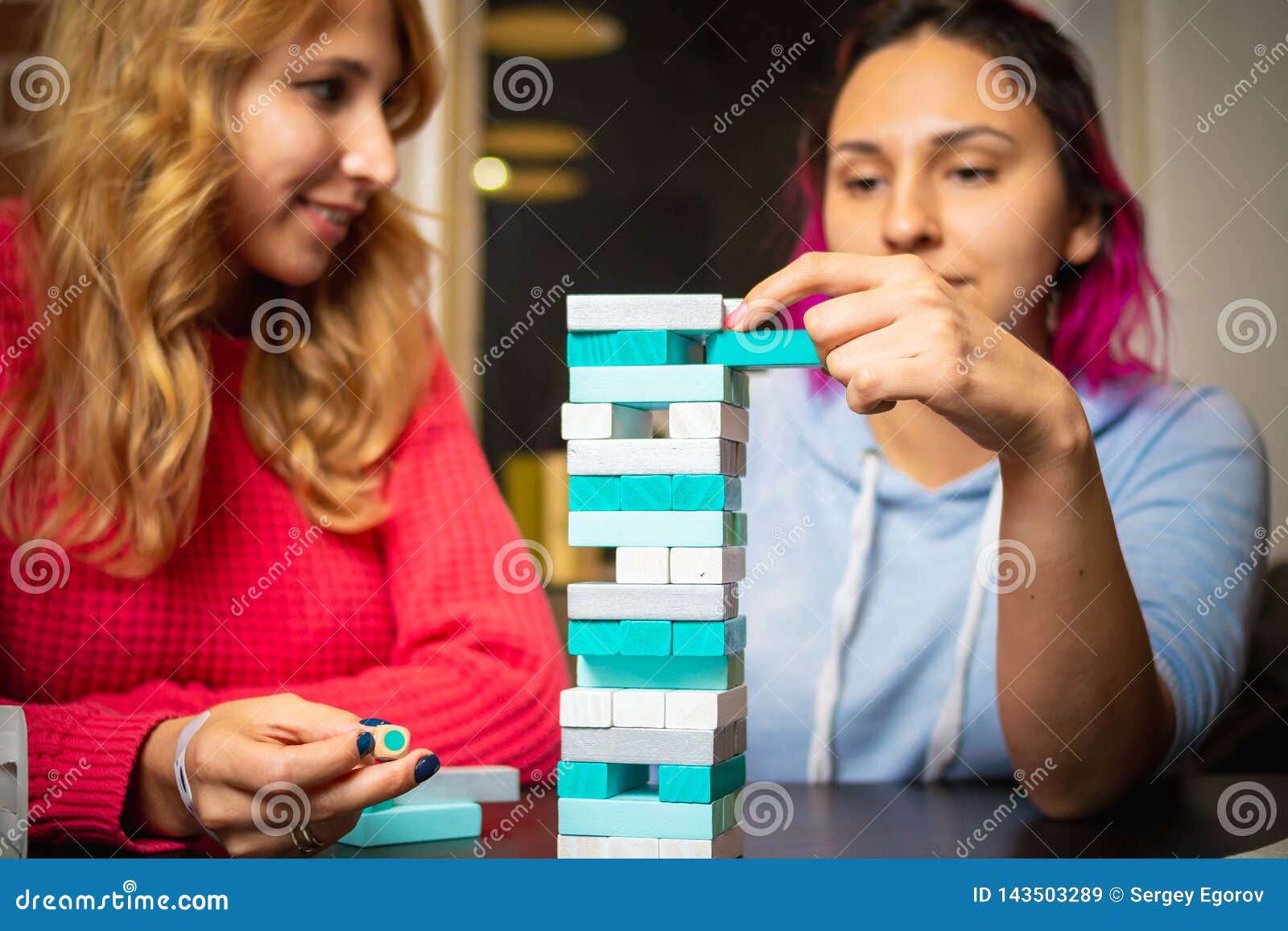 Two Young Women Playing Colored Jenga Stock Image - Image of game ...