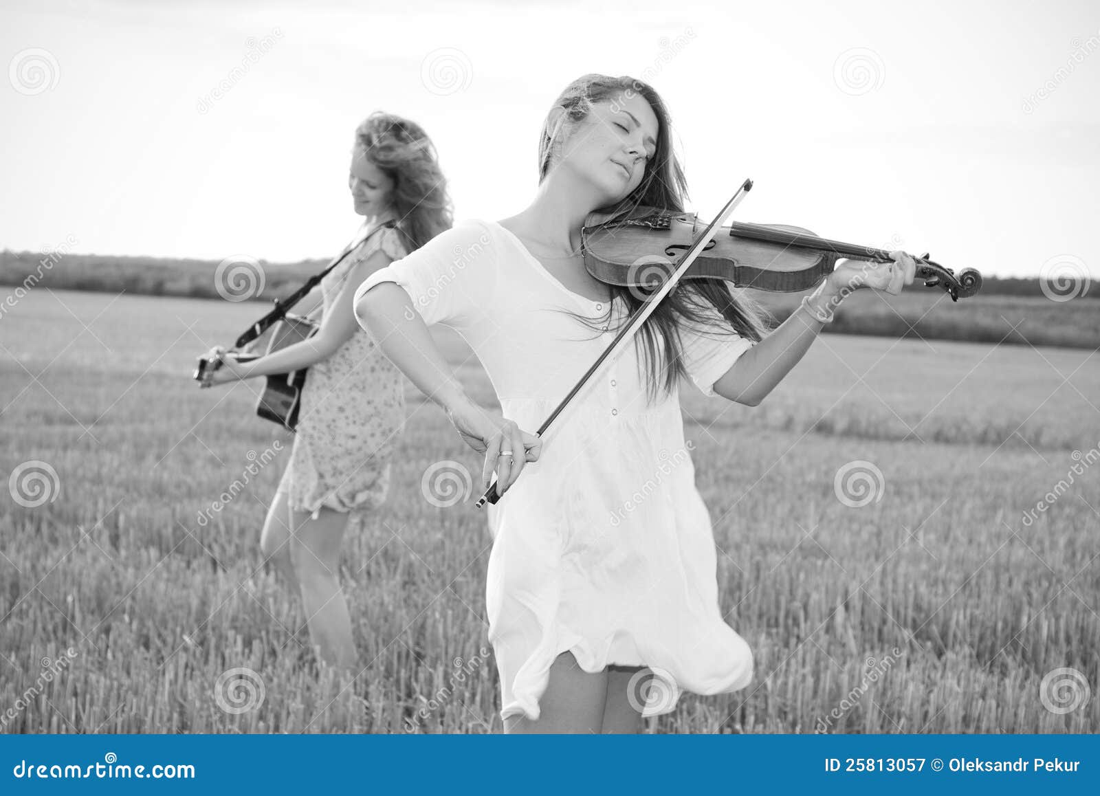 Two Young Women Playing Guitar Stock Image - Image of sunset, wind ...