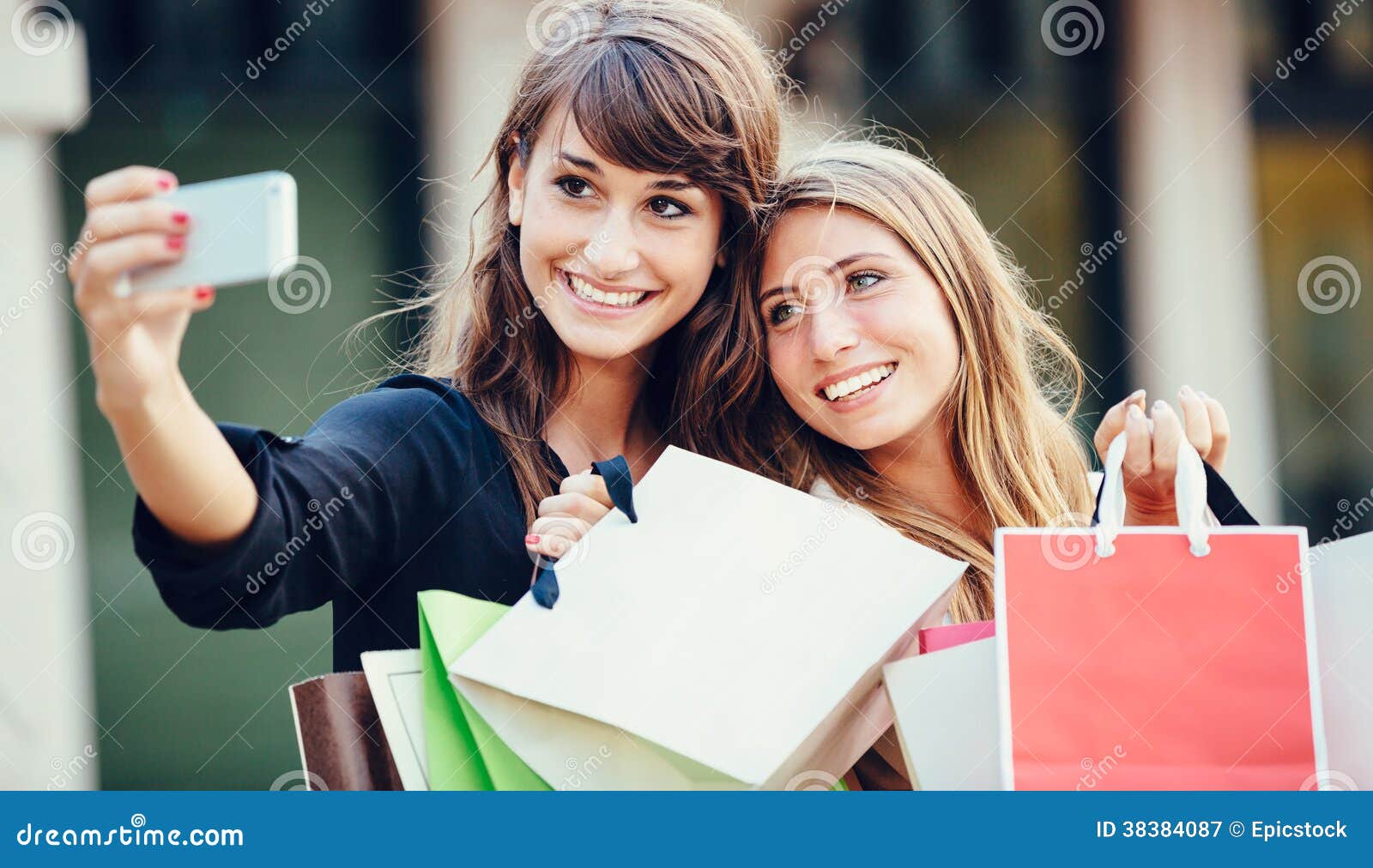 Two Young Women Shopping at the Mall Taking a Stock Image - Image of ...