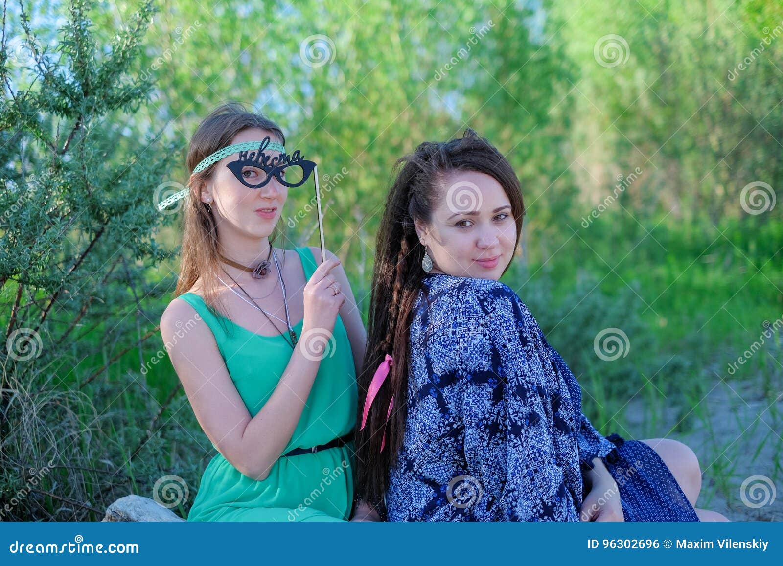 Two Young Women Sitting on Grass Having Good Time Stock Photo - Image ...