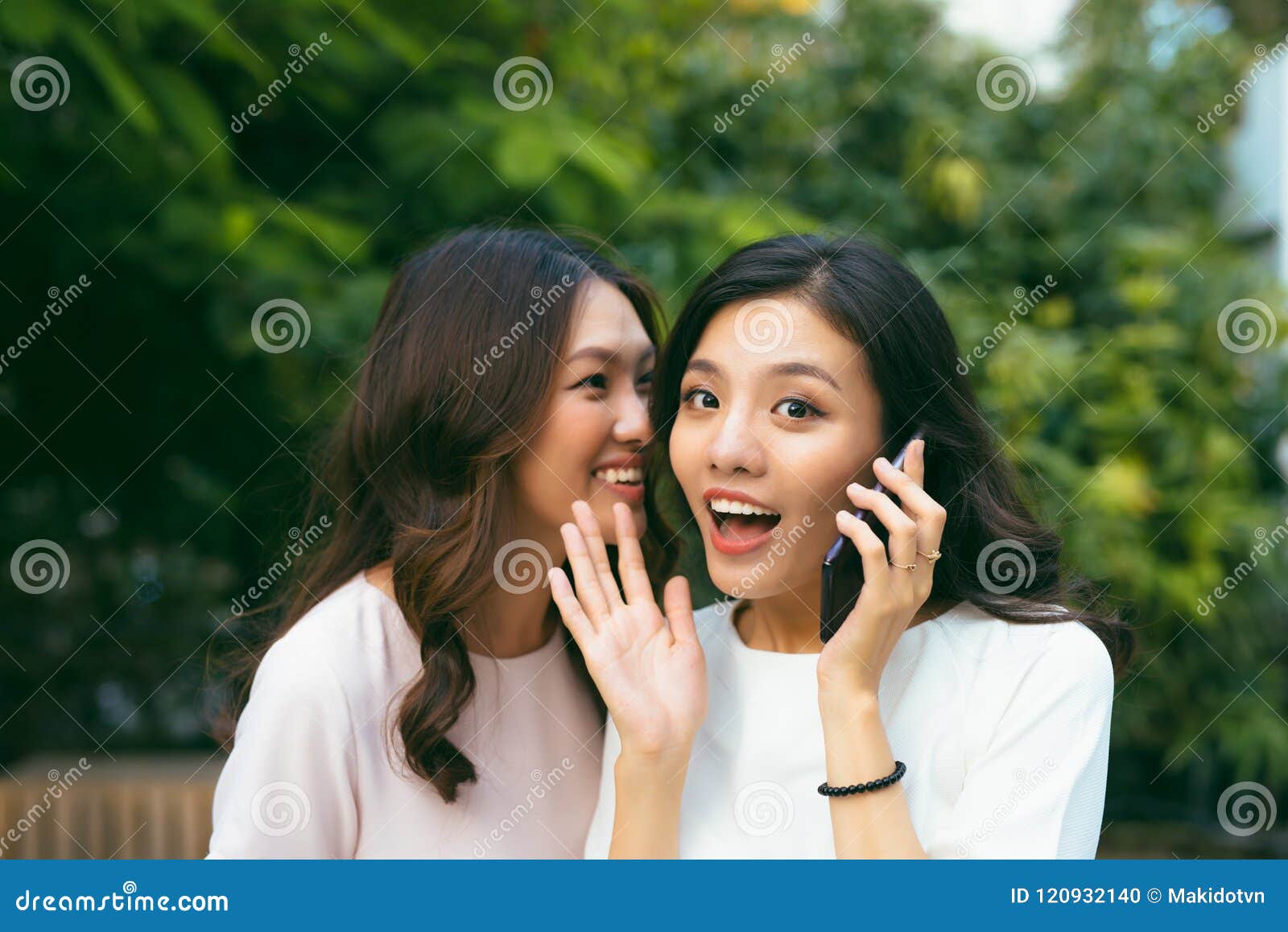 Two Young Women Socializing Outdoors. Stock Photo - Image of phone ...