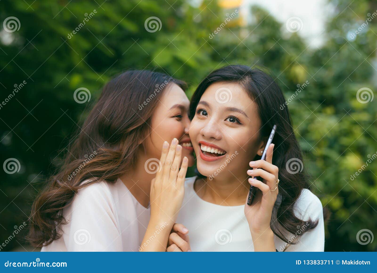 Two Young Women Socializing Outdoors Stock Image - Image of cell ...