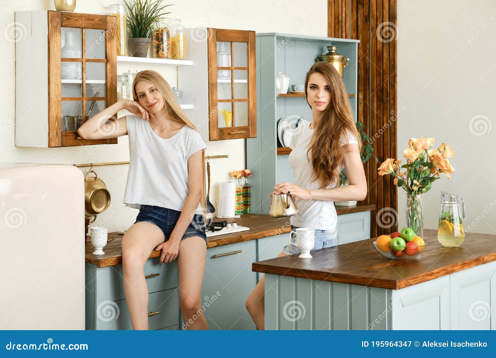 Two Young Women Talking in the Kitchen Stock Image - Image of indoor ...