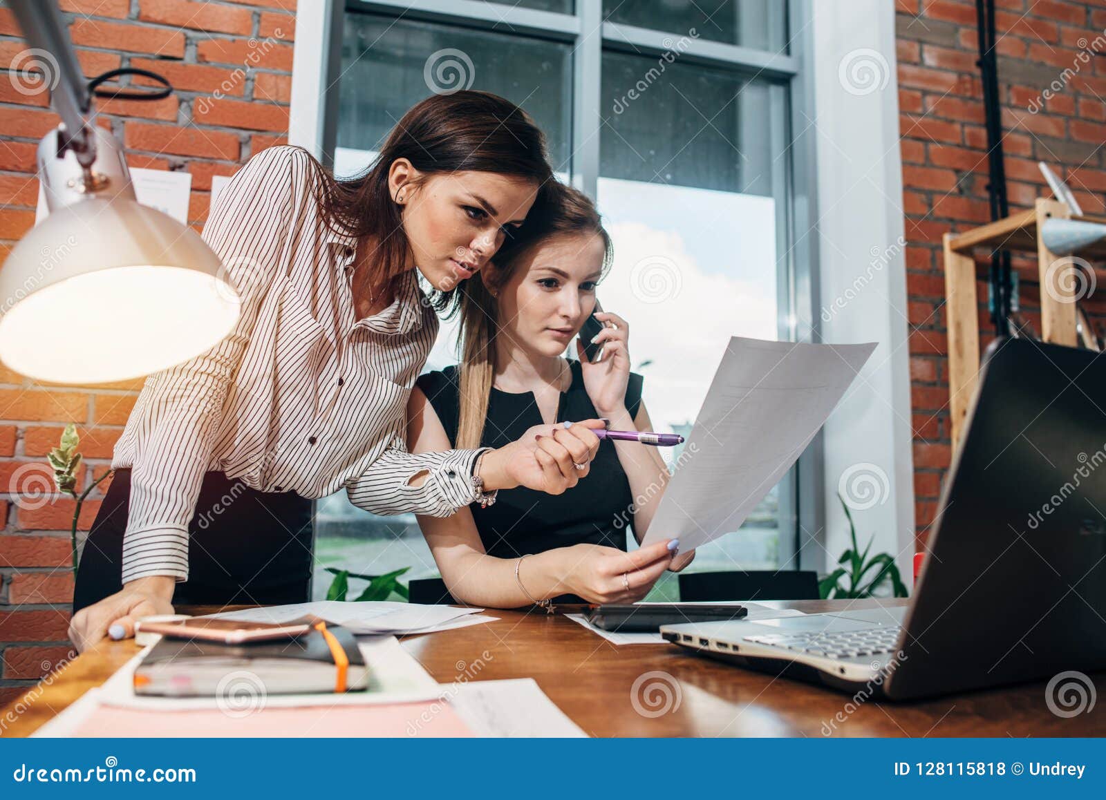 Two Young Women Working with Documents in Office Stock Photo - Image of ...