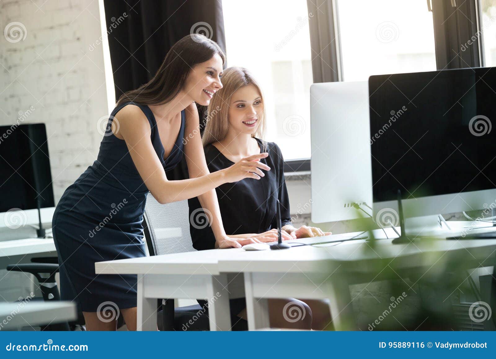 Two Young Women Working Together with Computer Stock Photo - Image of ...