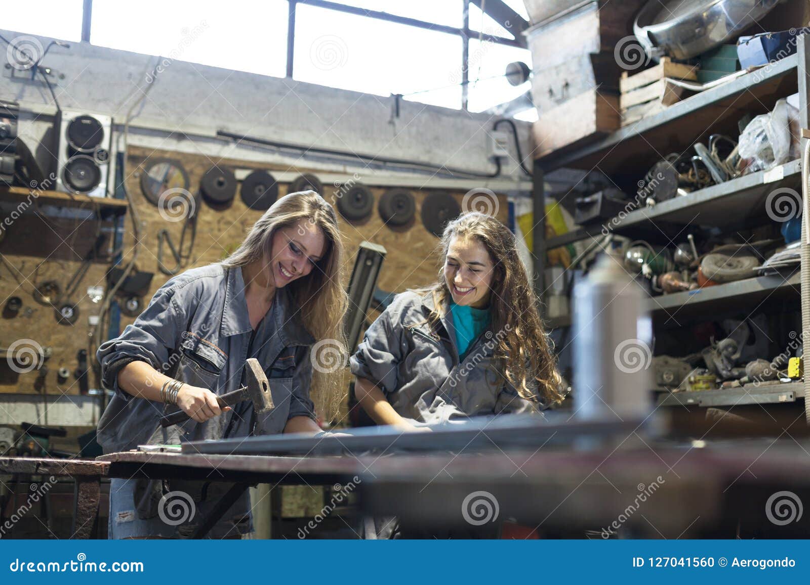 Two Young Women Working in Workshop Stock Photo - Image of machinery ...
