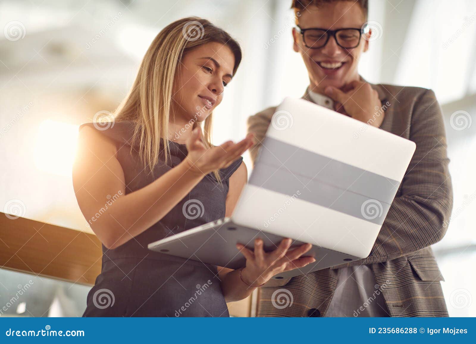 Two Young Work Colleagues Consulting Stock Photo - Image of ...