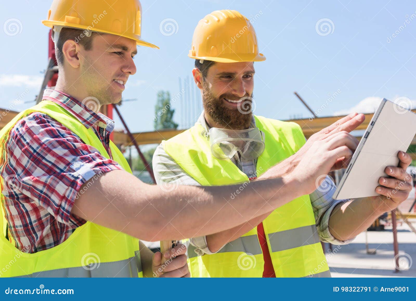 Two Young Workers Watching a Video or Communicating Online Throu Stock ...