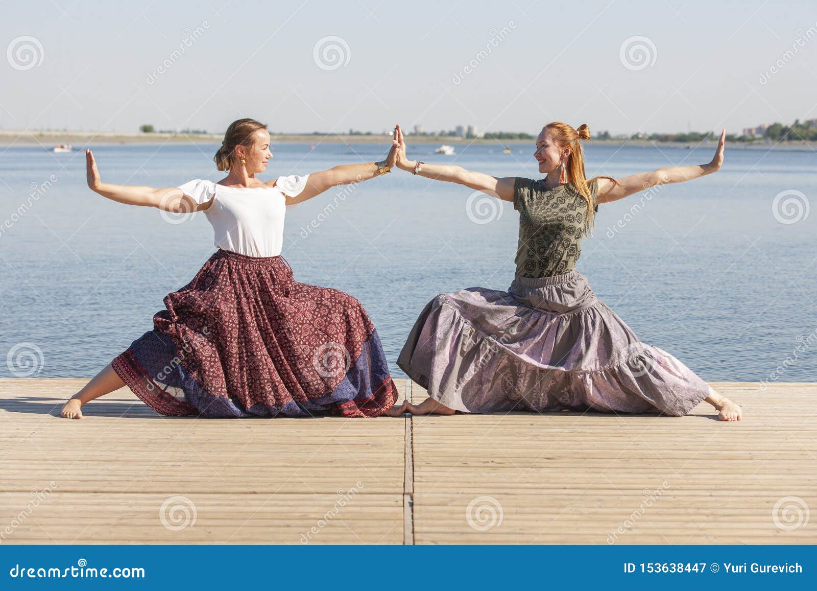 Two Young Yoga Practitioners Doing Yoga Exercises in Park Stock Image ...