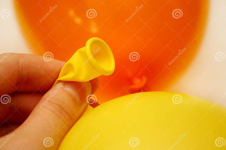 Tying yellow balloon stock image. Image of multicolor, deflate - 135867