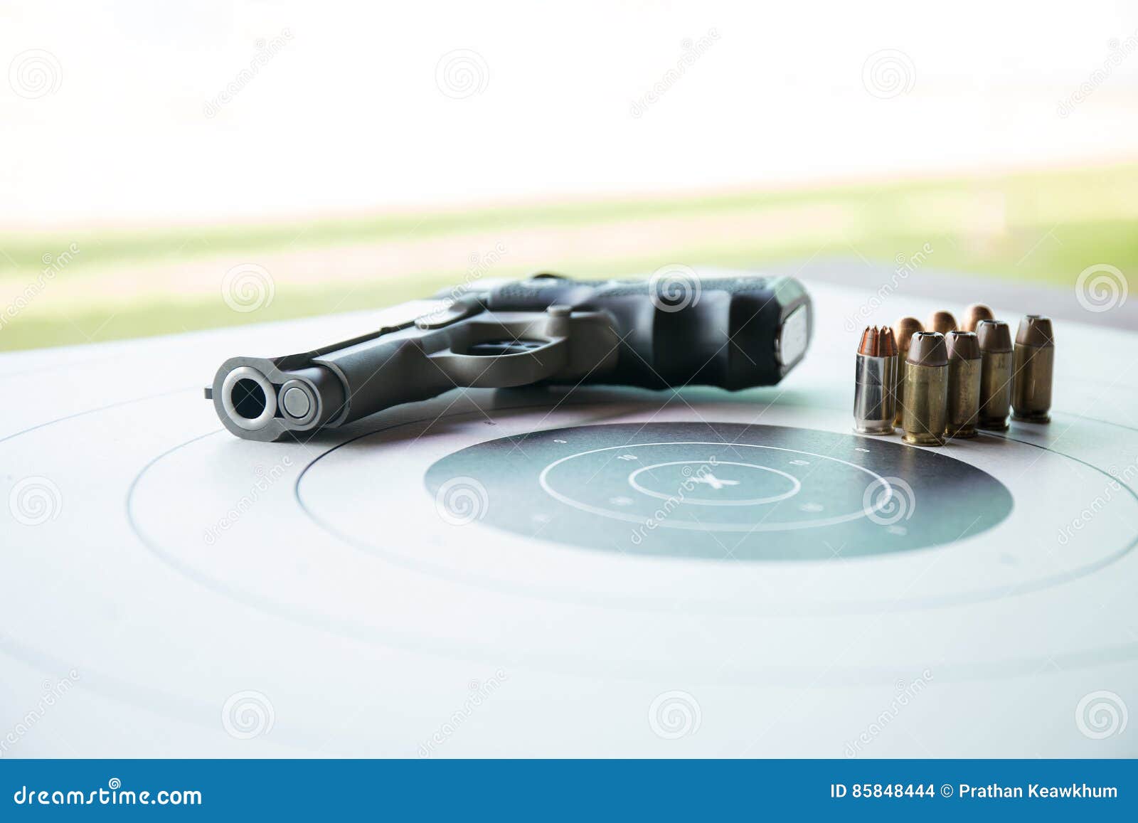 Type of .45 Bullets on Bullseye Target with Blurred Pistol Stock Photo ...