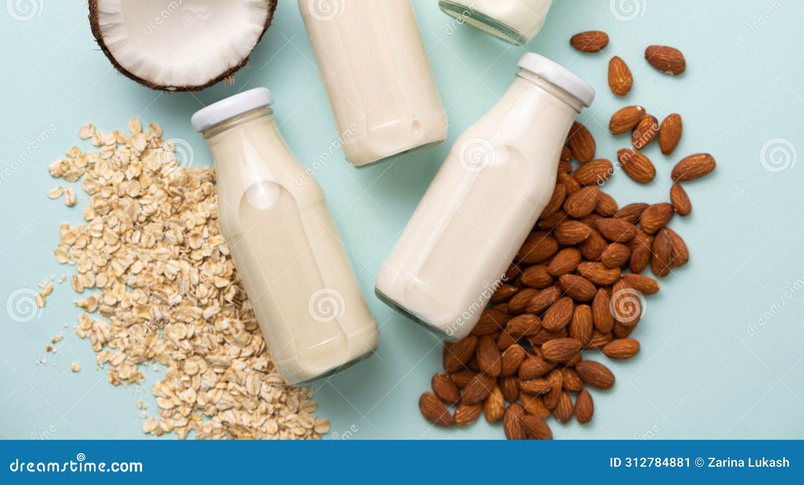 Types of Plant-based Milk in Glass Bottles on Blue Background, Top View ...