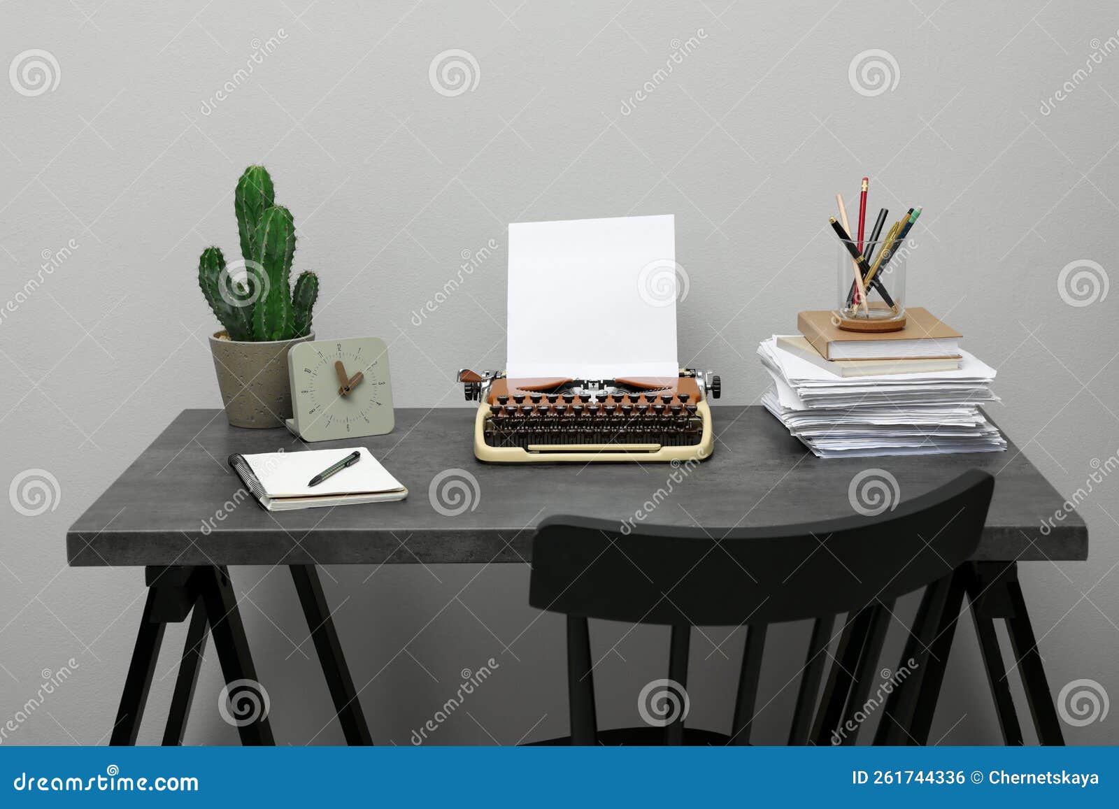 Typewriter and Stack of Papers on Dark Table Near Light Grey Wall ...