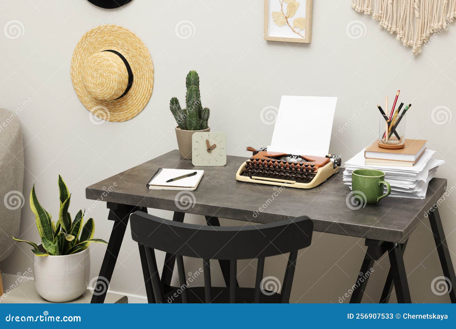 Typewriter and Stack of Papers on Dark Table in Room. Writer`s ...