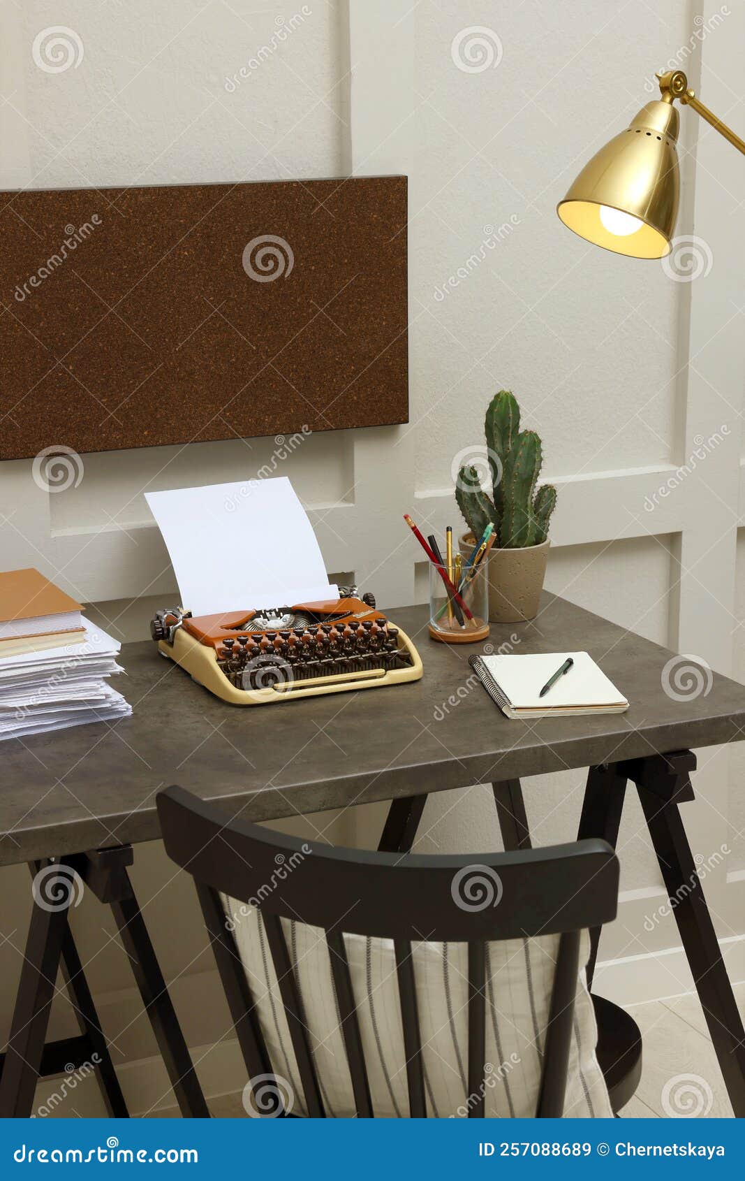 Typewriter and Stack of Papers on Dark Table in Room. Writer`s ...