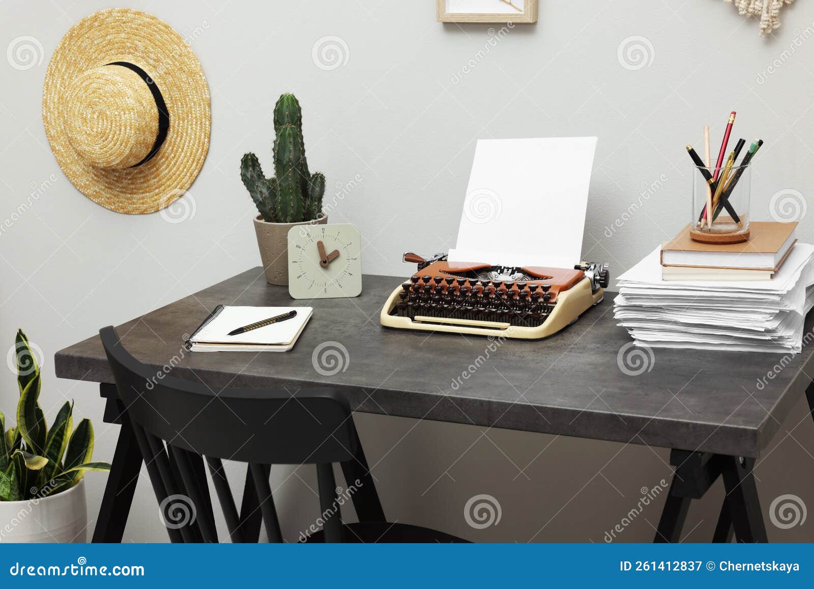 Typewriter and Stack of Papers on Dark Table in Room. Writer`s ...