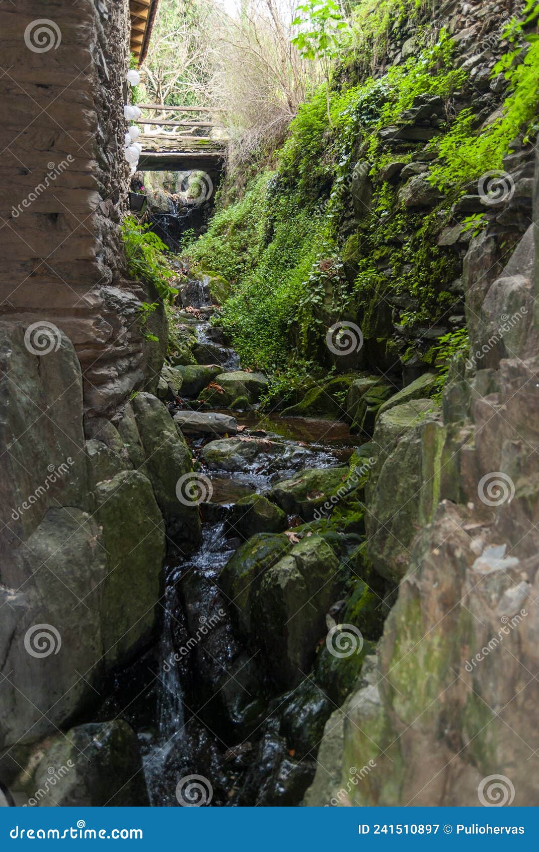 Typical Corner with a Small Waterfall with Moss Crossing the Streets in ...