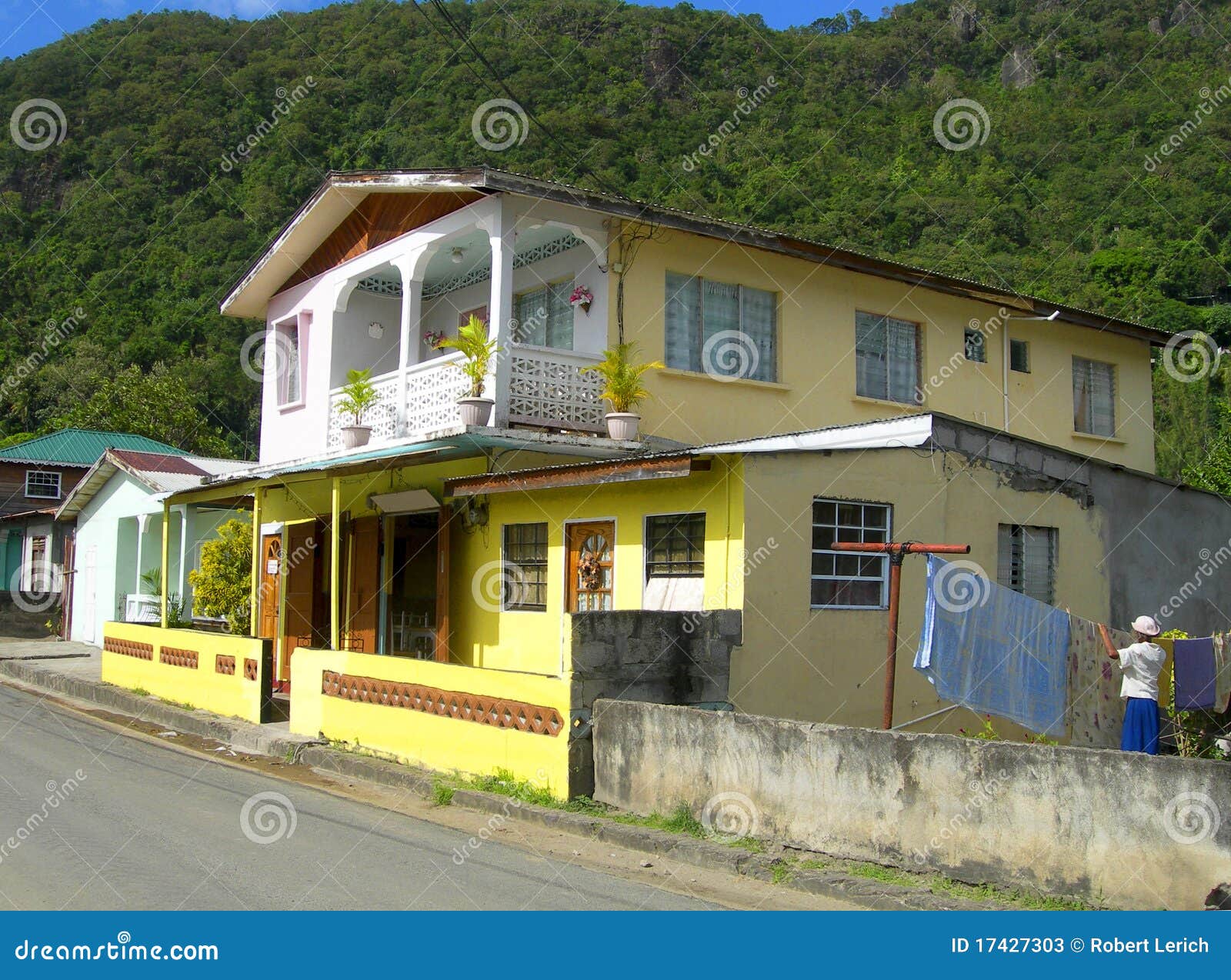 Typical House With Blue Balconies, Stairs And Flowers. Little Girl On ...