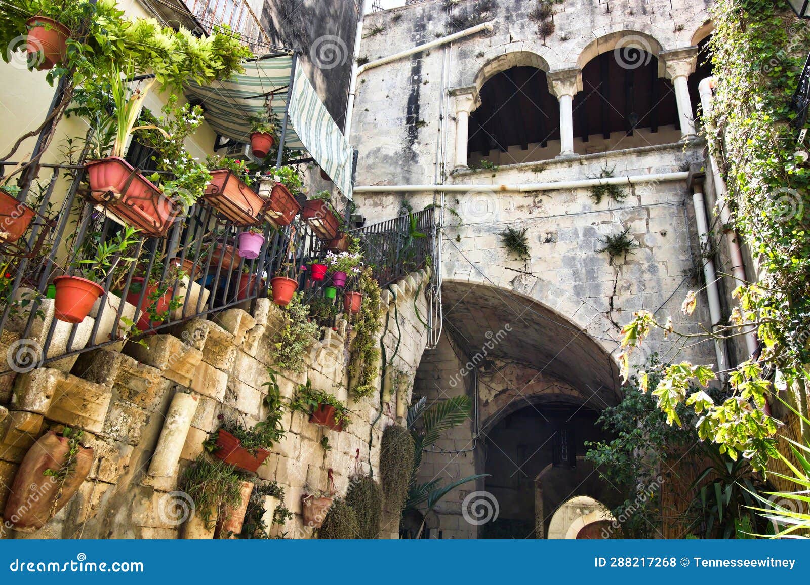 A Typical Old Italian Courtyard with Steps and Balcony with Arches ...