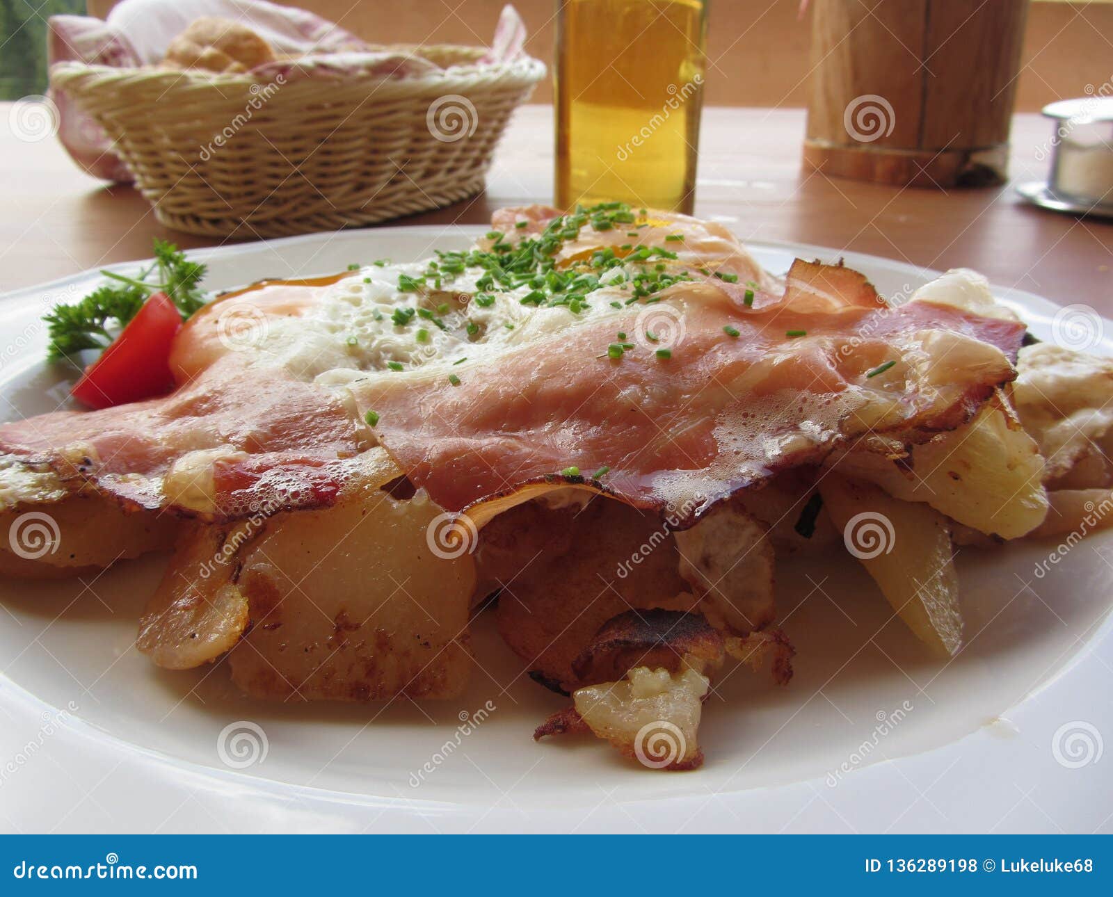 Typical South Tyrolean Dish with Speck, Fried Eggs, Potatoes and Chive ...
