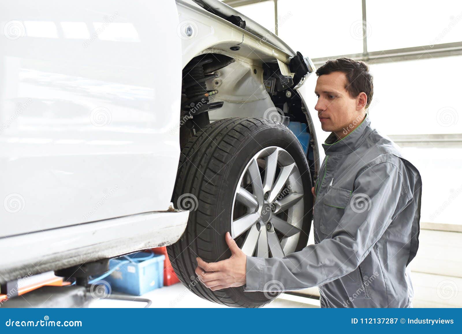 Tyre Change in a Workshop - Assembler in Working Clothes Stock Image ...