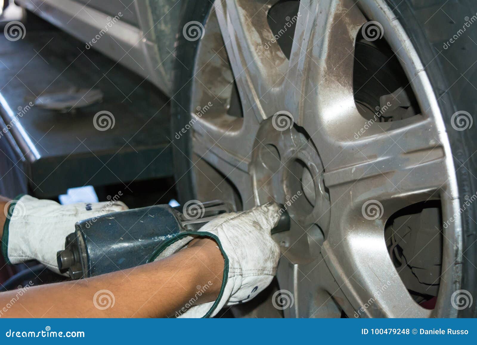 Tyre Repairer Fixing a Wheel Using an Impact Wrench Stock Photo - Image ...