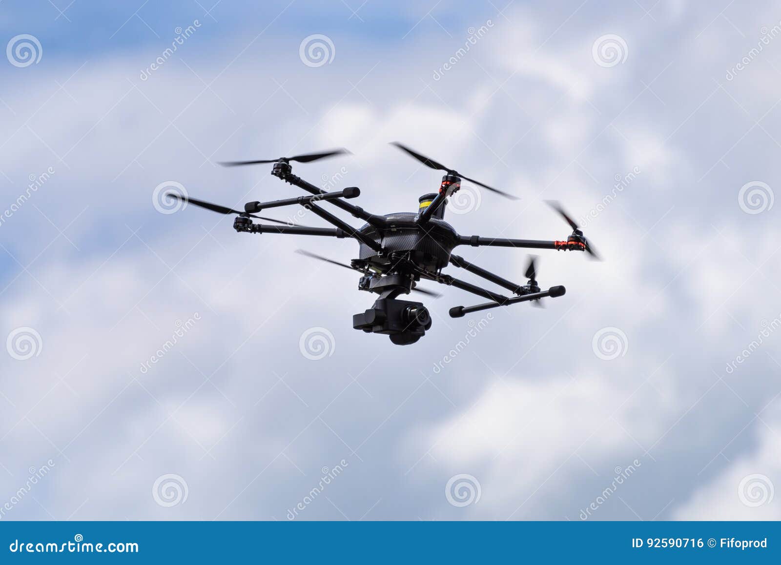 UAV Drone Copter High Up in the Blue Sky Surrounded by Clouds Stock ...