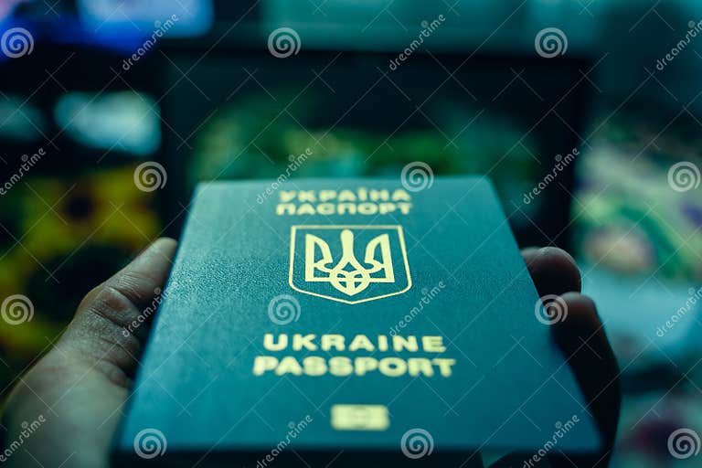 Ukrainian Biometric Passport In Hand Close Up In Cold Blue Colors Stock